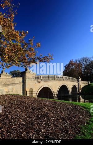 Autumn colours looking at the Lion Bridge of Burghley house, an ...