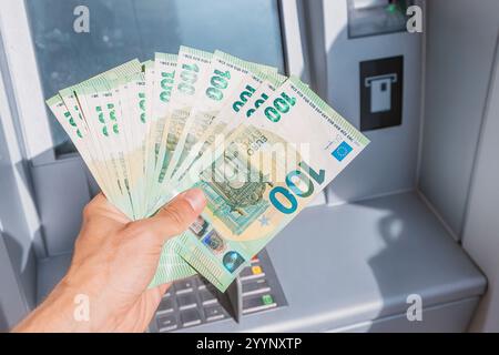 hand with money Euro banknotes withdrawn from the ATM of an European ...