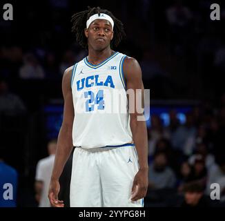 UCLA forward William Kyle III (24) drives on Wisconsin forward Nolan ...