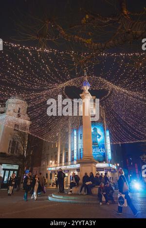 The Seven Dials Monument illuminated with festive canopy lights during ...
