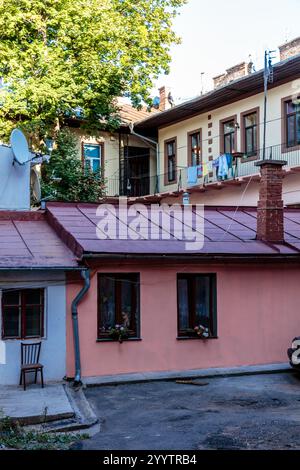 Exterior of a house with a balcony surrounded by trees on a sunny ...