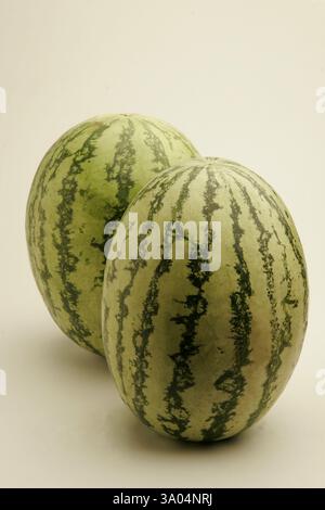 Fruits, Two full watermelons with light and dark green stripes watery ...
