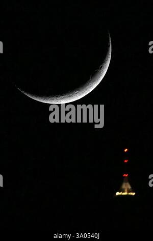 The half moon can be seen in the sky in Warsaw, Poland on 25 May, 2026 ...