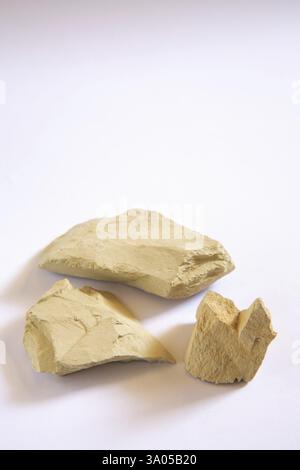 Herbal multani mitti stone on white background Stock Photo - Alamy