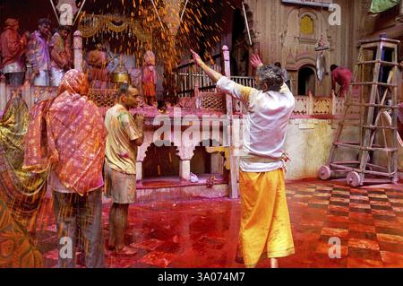Indian devotees dancing, singing, rejoicing and playing Holi at Radha ...