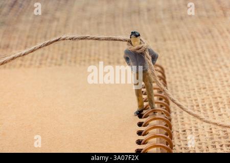 Figurine man with a rope on the neck Stock Photo - Alamy