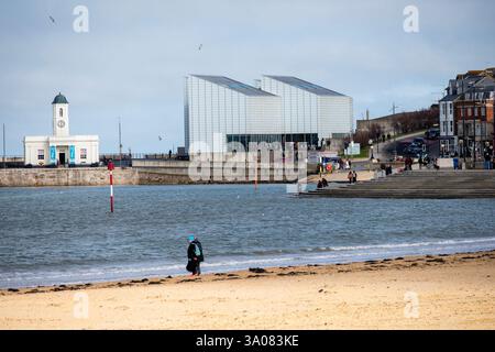 Margate, UK. 01st Mar, 2025. A cyclist walks beneath of the sign of the ...