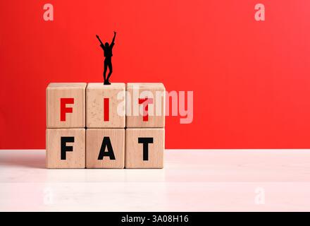 Word FAT on wooden cubes over bright background with copy space Stock ...