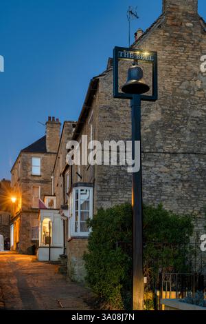 The Bell pub sign at dusk. Charlbury, Oxfordshire, England Stock Photo ...