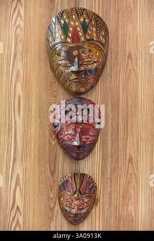 Traditional Indonesian handcrafted masks with wooden background. Asian ...