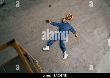 Top view of dead factory worker that lying on the ground Stock Photo ...