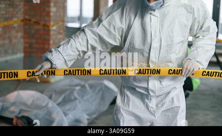 Holding caution police tape. Detectives are collecting evidence in a ...