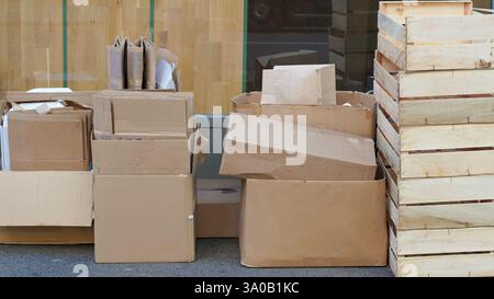 Compressed cardboard stacked outdoors, ready for eco waste processing ...