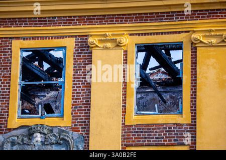 Dassow, Germany. 03rd Mar, 2025. Charred roof beams lie on the remains ...