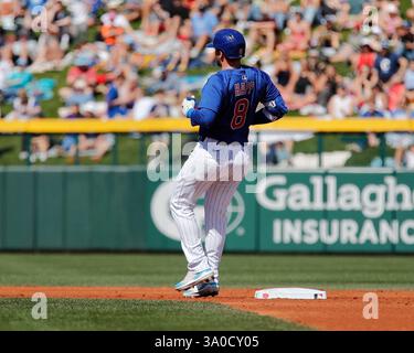 Chicago Cubs' Ian Happ hits a sacrifice fly RBI during the third inning ...