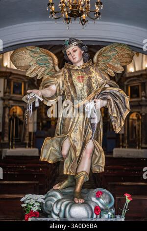 Historic sculpture of Archangel Raphael in the church of San Juan de ...