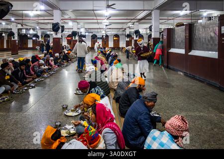 Visitors dining at the langar, a Sikh community-run kitchen offering ...