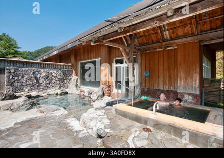 Visitors enjoy the rotenburo outdoor bath at Seifuso in Odate City ...