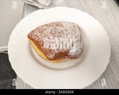 Powdered icing sugar ring donut, A glazed, yeast raised, American style ...