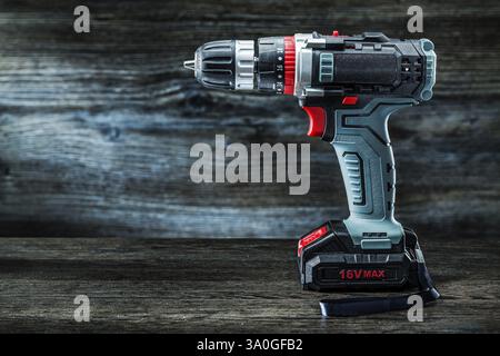 cordless drill driver electric screwdriver on vintage wood background ...