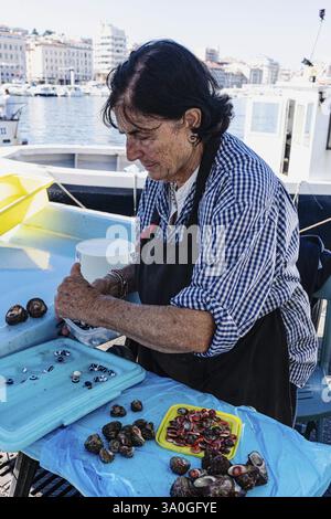 Woman selling lucky charms, otoliths of fish, at the fish market, Old ...