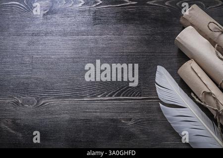 Ancient paper scrolls feather on wooden board copyspace Stock Photo - Alamy