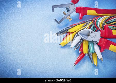 Cable crocodiles insulated wire strippers nippers on blue background ...