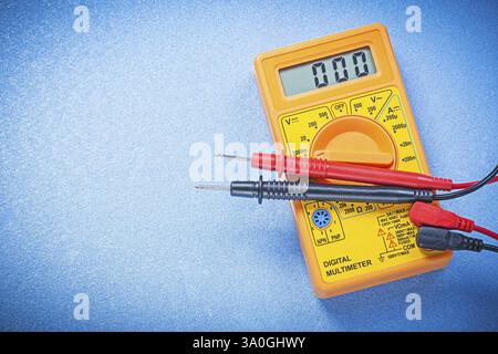 Electric digital multimeter on blue background top view electricity ...