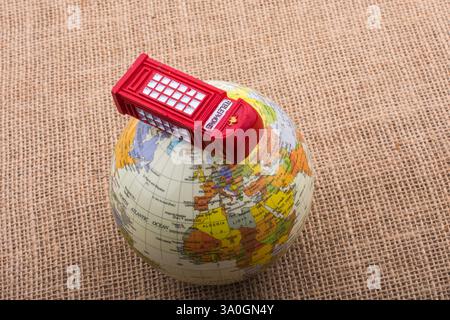 Globe with a telephone booth on canvas background Stock Photo - Alamy