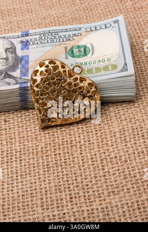 heart icon bundle of US dollar placed on a linen canvas Stock Photo - Alamy