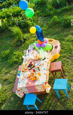 An aerial shot of colorful balloons in a row near a beach of a sea ...