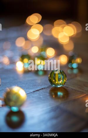 A shallow focus shot of antique colorful glass cup, vase and bottles on ...