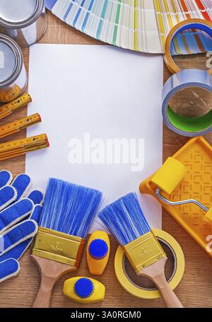 Set of paint roller brushes protective gloves on wood board ...
