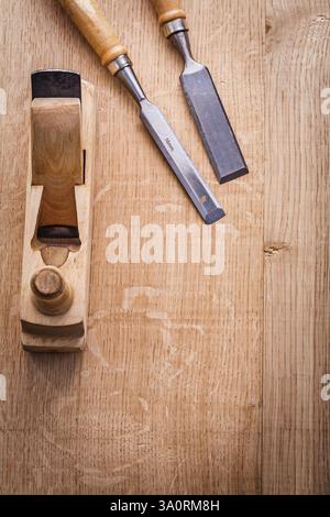 chisels and woodworkers plane on wooden board construction concept ...