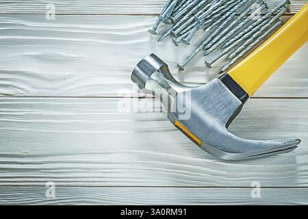 Claw hammer stainless nails on wooden board construction concept Stock ...