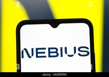In this photo illustration, a Nebius logo is seen on a smartphone and ...