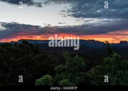 Stunning Sedona, Arizona sunset over red rock formations and greenery ...