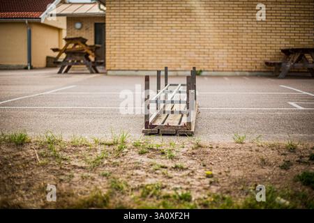 Upside down bench on schoolyard during summer break Stock Photo - Alamy