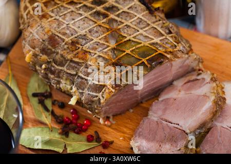 Appetizing pork ham with spices on a cutting board Stock Photo - Alamy