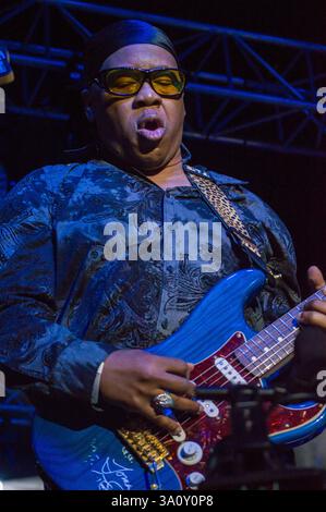 Guitarist in the George Clinton band is shown performing onstage during ...