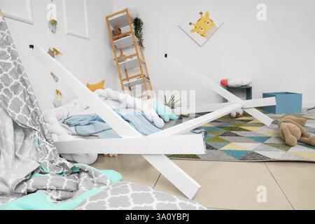 Interior of messy children's room with broken bed and shelf unit Stock ...