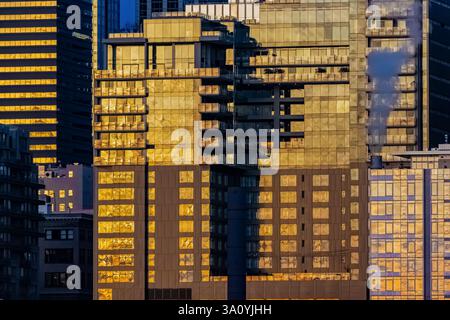 Waterfront buildings reflecting winter sunset in Seattle, Washington ...