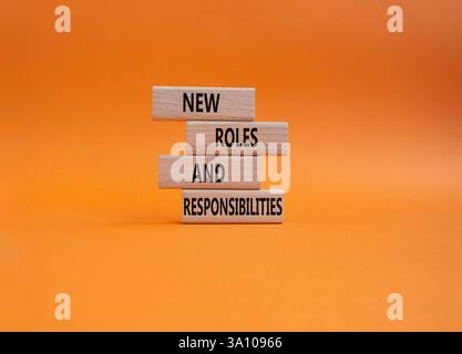 New roles and responsibilities symbol. Wooden blocks with words 'New ...