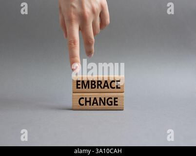 Embrace change symbol. Concept word Embrace change on wooden blocks ...