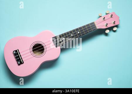 One ukulele on light blue background, top view. Space for text Stock ...