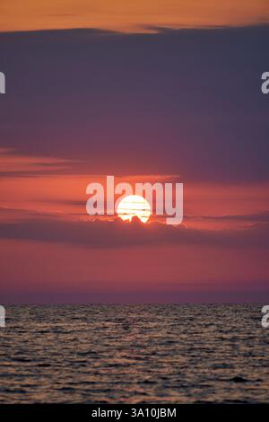 An amazing shot of a dramatic sunset over a field Stock Photo - Alamy