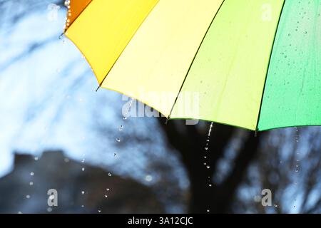 Open bright umbrella under pouring rain outdoors, closeup Stock Photo ...