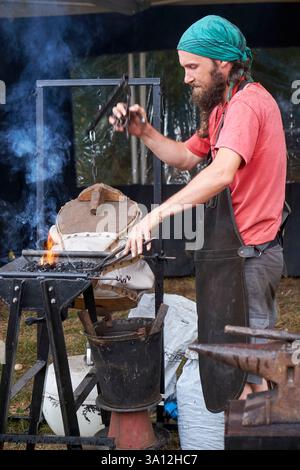 Reconstruction of a medieval forge at a historical festival: Kaluzhskiy ...
