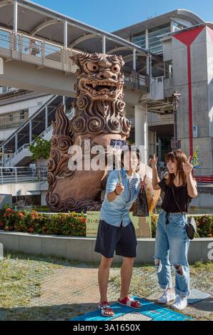 Visitors take selfies in front of a clay wall marked ÇÊRoland GarrosÊÈ ...