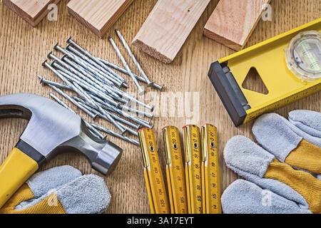 gloves hammer level nails planks on wooden board Stock Photo - Alamy